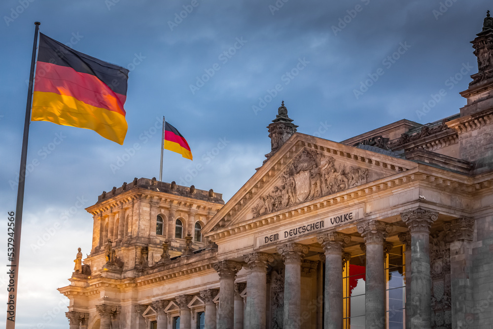 Reichstag building, seat of the German Parliament with national flag ...