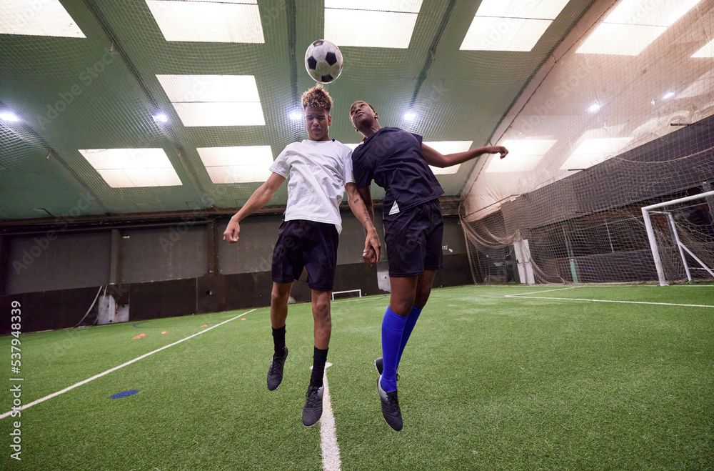 Teen athletes hitting football ball with heads Stock Photo | Adobe Stock