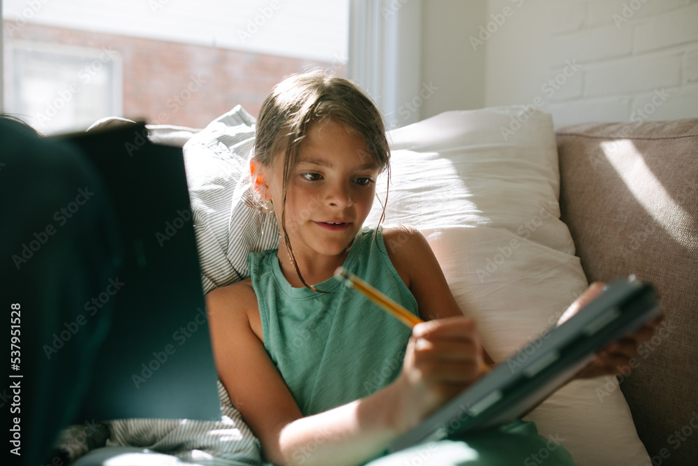 kids do homework on couch Stock Photo | Adobe Stock
