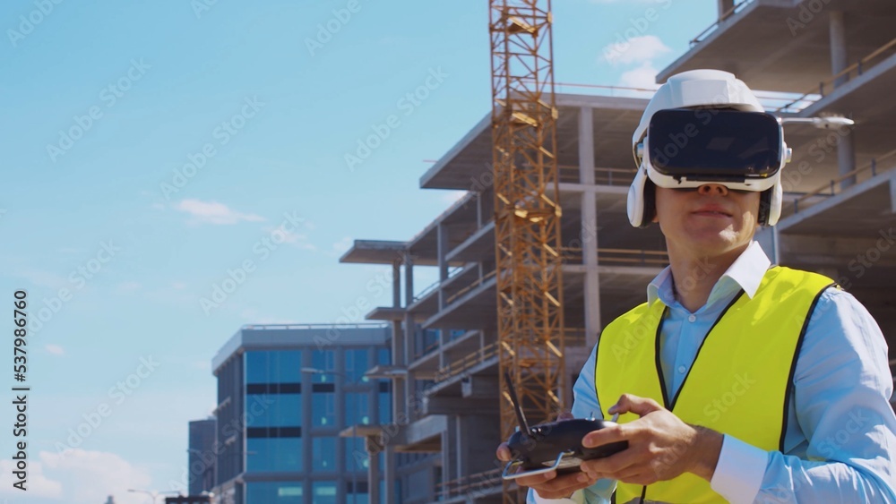 Professional drone operator in virtual reality helmet standing in front ...