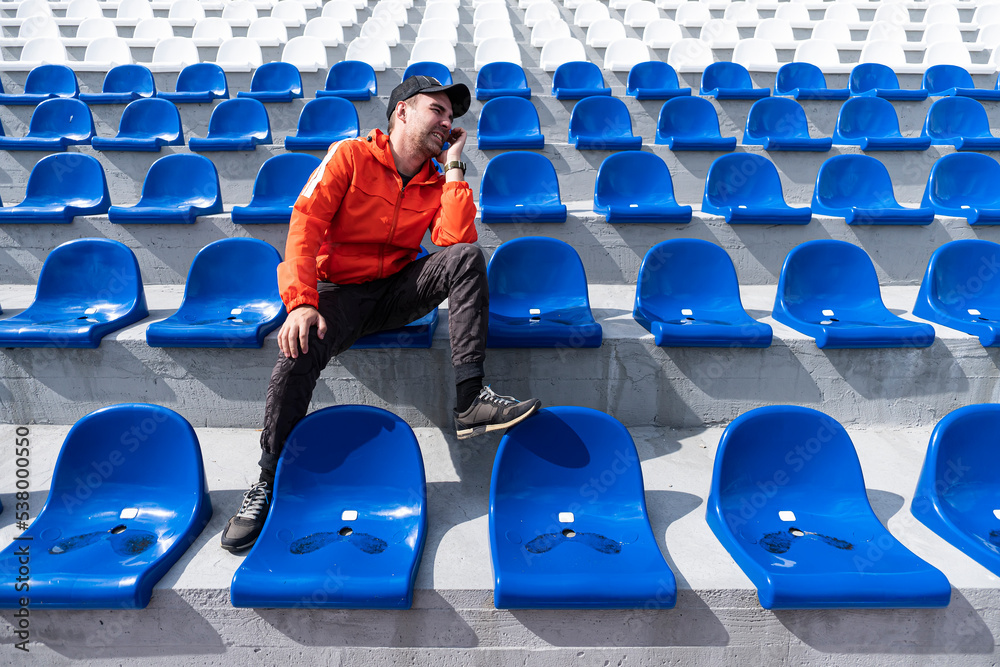 Football fans clapping on the podium of the stadium. one single fan at ...