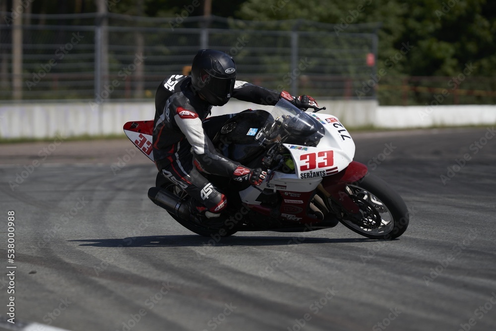 12-09-2022 Riga, Latvia a person riding a motorcycle on a race track, a ...