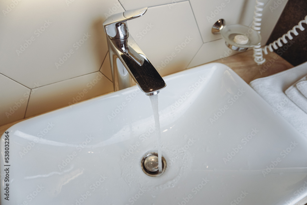 Running Water From Faucet Over Sink A Closeup Shot Of Water Flowing