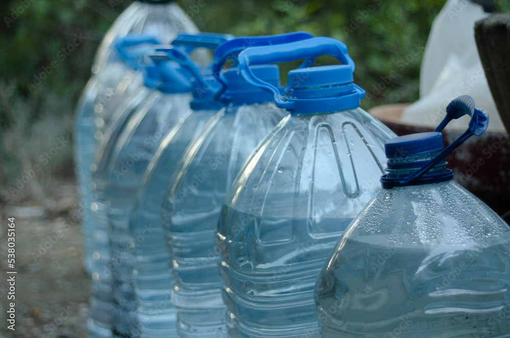 Recycled water bottles with rainwater. Save water. Concept of global ...