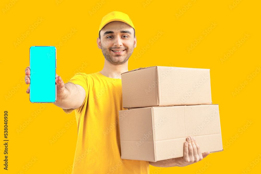 Delivery man with a box, smartphone. Courier in uniform cap and t-shirt ...