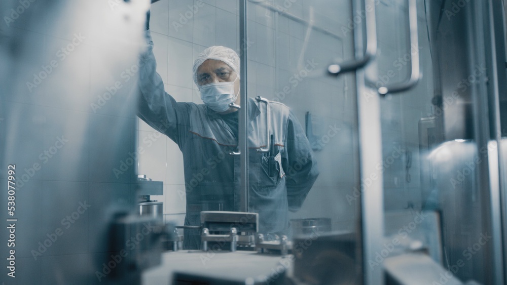 Machine operator working on pharmaceutical production line. Automatic ...