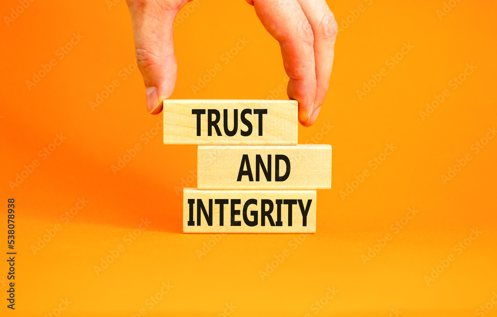Trust and integrity symbol. Concept words Trust and integrity on wooden ...