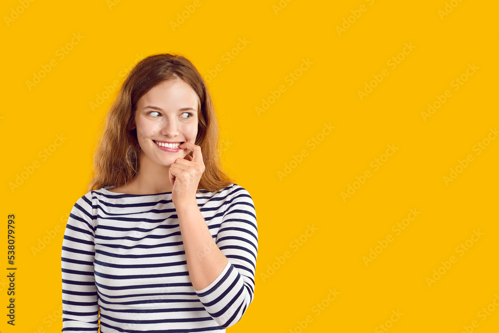 Young woman looks aside with funny awkward smile on face. Beautiful ...