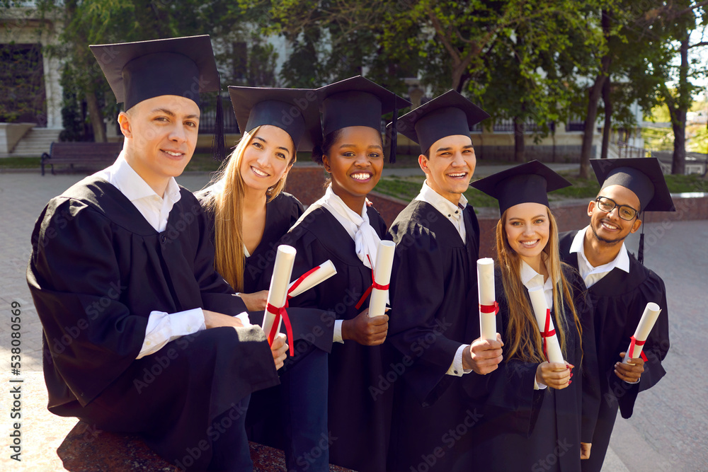 Happy university graduates celebrate their graduation and rejoice at ...