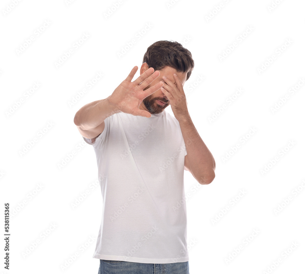 Embarrassed man covering face with hands on white background Stock ...