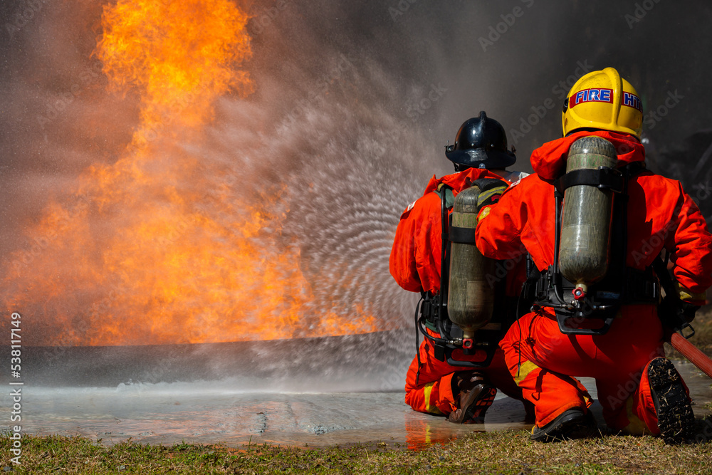 Firefighter on duty firefighting, Asian fireman spraying high pressure ...