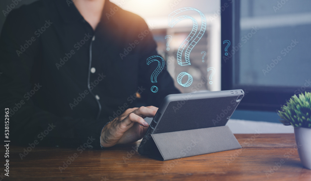 Question mark symbol with hologram on hand of man with tablet. Thinking ...