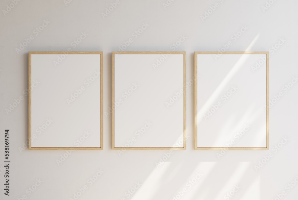 Three empty wooden frames on white wall in row. Blank space. Template for your content. 3D ...
