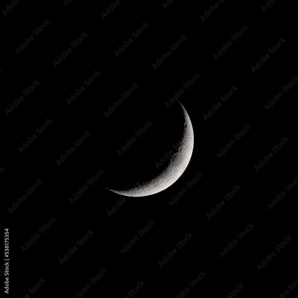 Crescent moon shining bright in the dark night sky Stock Photo | Adobe ...