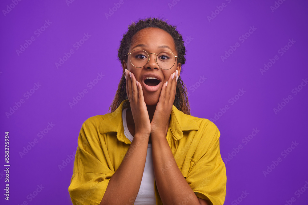 Young surprised African American woman gen z opening mouth puts hands ...