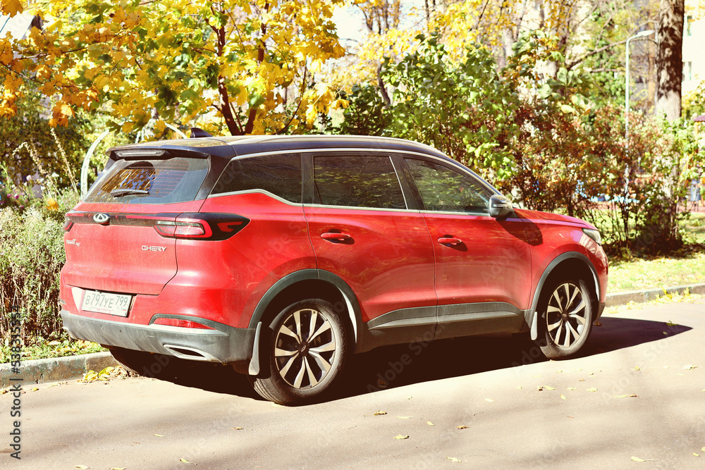 car Chery Tiggo 7 Pro Test parked in backyard. Rear side view of red ...