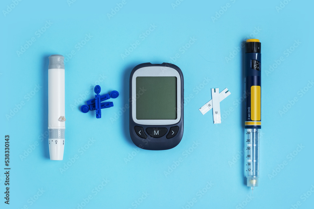 Measuring blood sugar. Glucometer, insulin pen, lancet and test strip ...