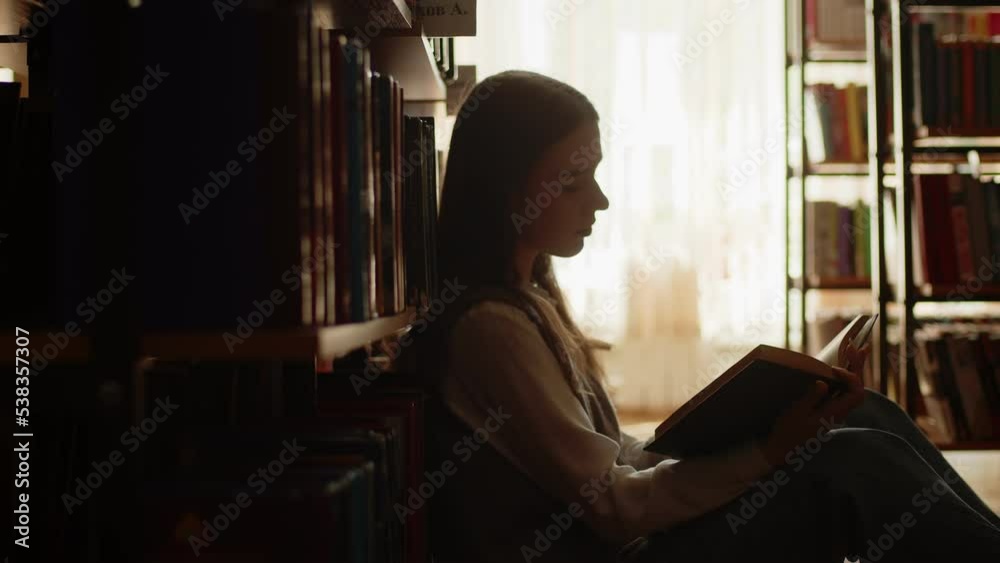 Caucasian woman with long hair is sitting on the floor leaning on a ...