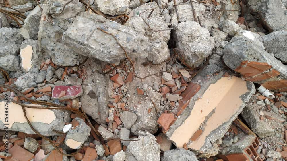 Rubble on the demolition site of a reinforced concrete building. Pile ...