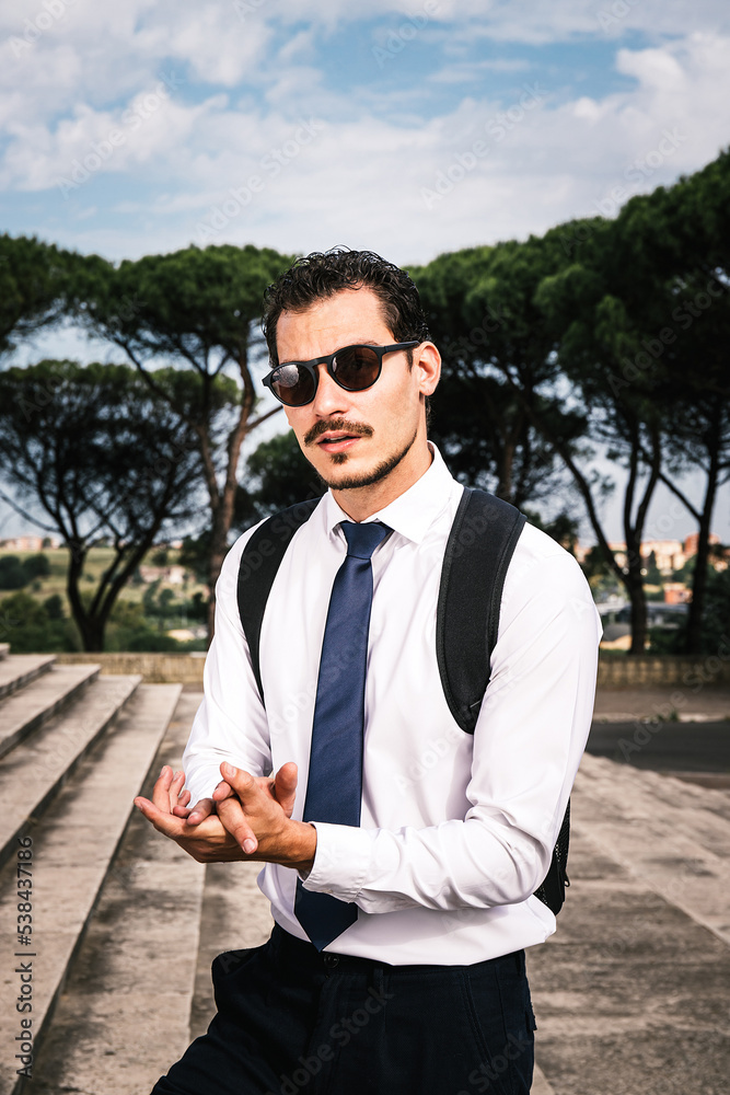 Beautiful businessman is posing on the travertine stairs before ...