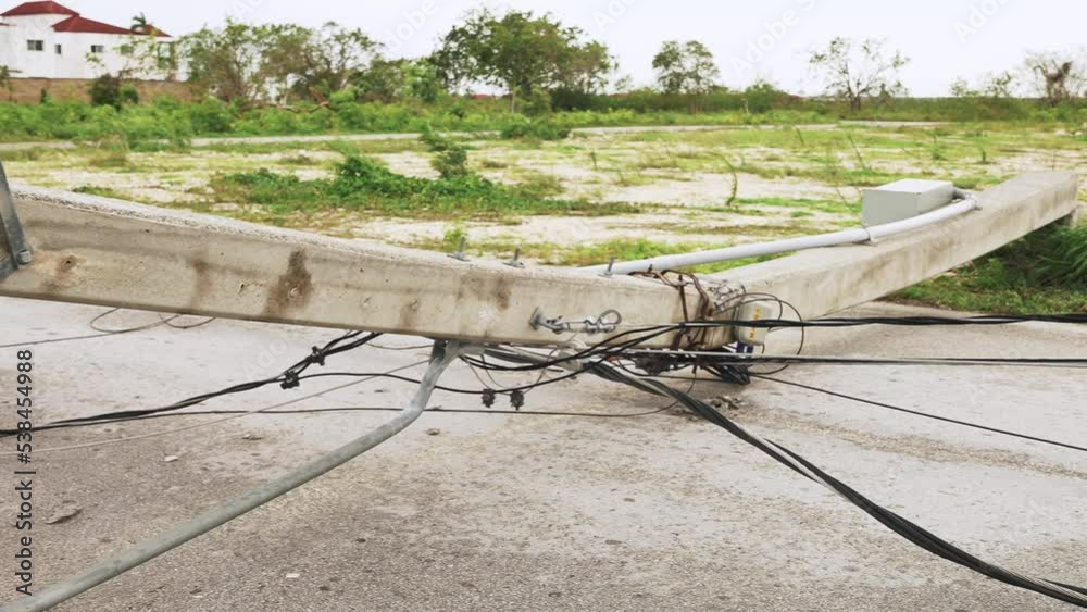 Fallen power line pole and cables after a tropical hurricane. Aftermath ...