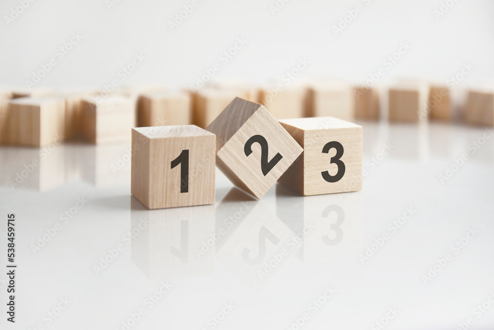 text 123 on wooden blocks with letters on a white background ...