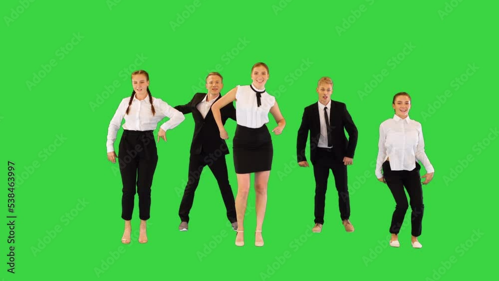 A team of young dancers in office suits performs a synchronous dance ...