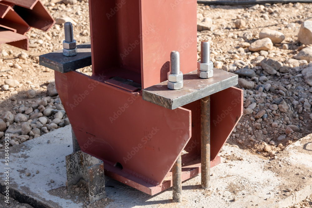 The base of the metal beam is installed and fixed on a concrete ...