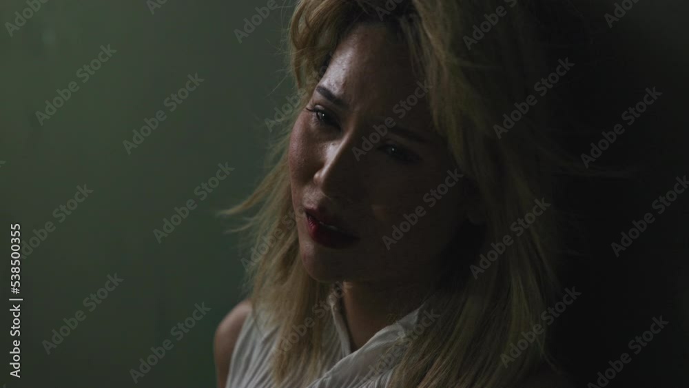 The abducted woman's wrists and feet are bound in red rope, with no way ...