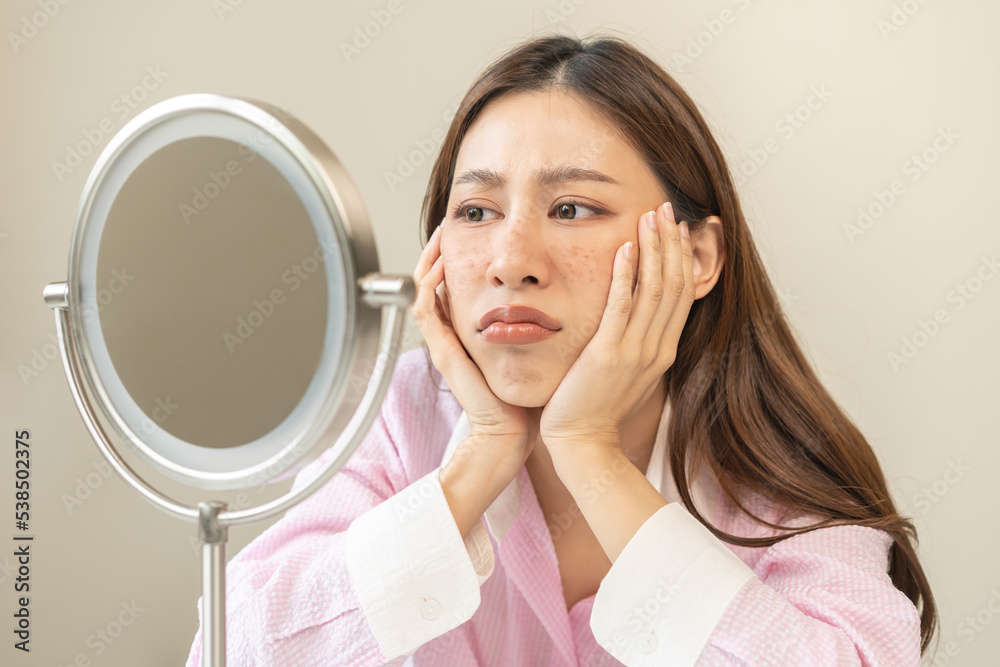 Dermatology, expression face worry asian young woman looking mirror ...