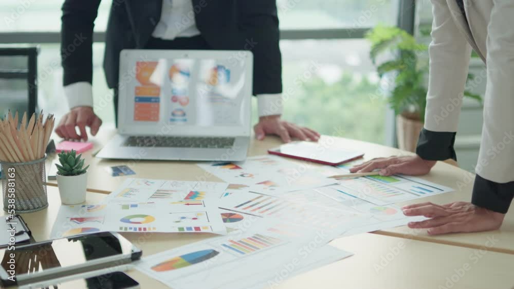 Close-up hands of business people group meeting brainstorming ideas about new paperwork shows ...