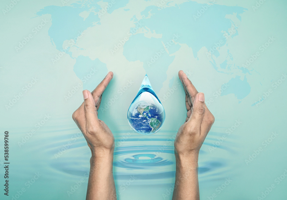 Hand hold world in clean water drop on and fresh blue water ripples ...