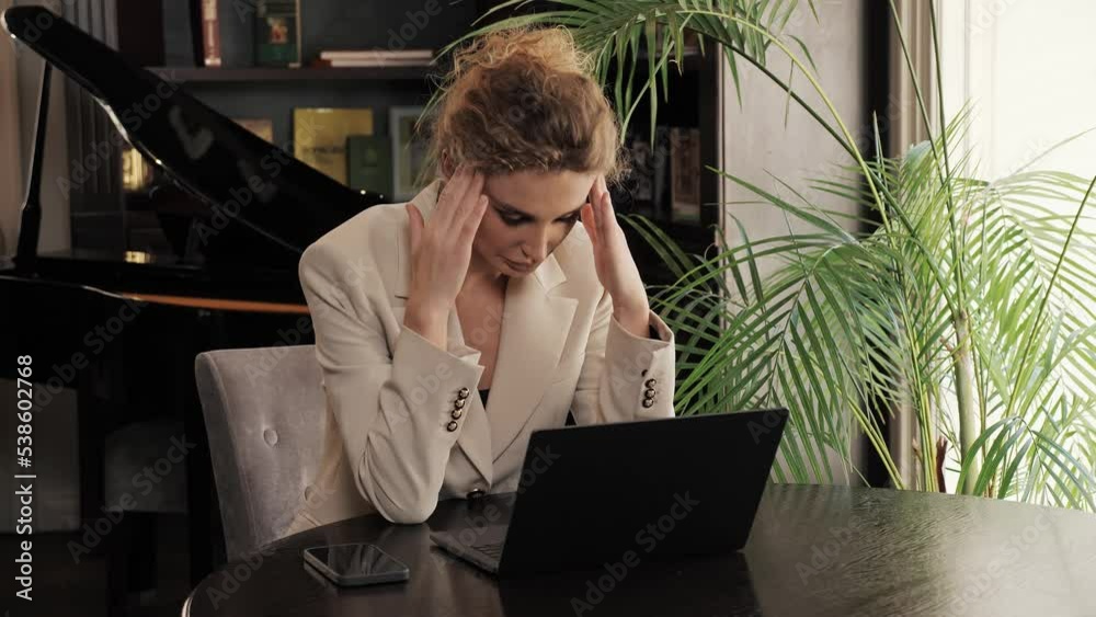 Tired depressed businesswoman in formal suit with blue eyes and curly ...