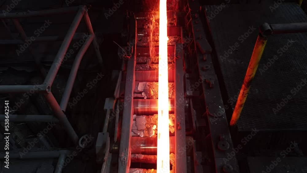 hot metal billet moves on rollers in a hot metallurgical shop. rolling ...