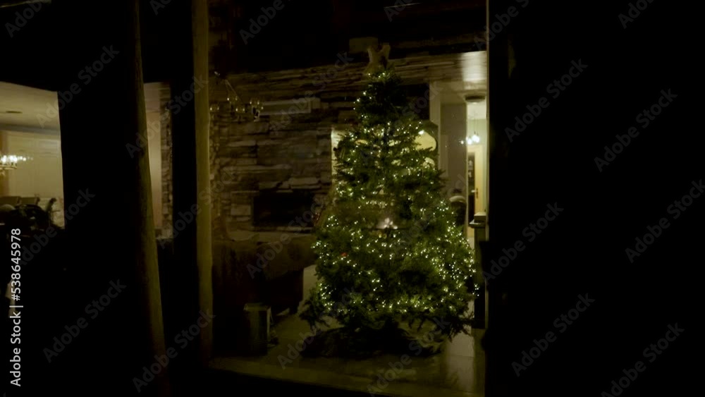 Slow motion - Full shot of a beautiful Christmas tree with lights ...