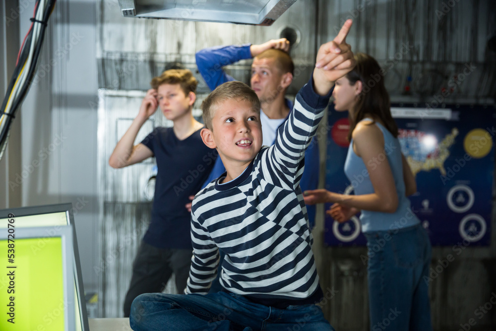 Emotional tween boy with his parents and older brother trying to get ...