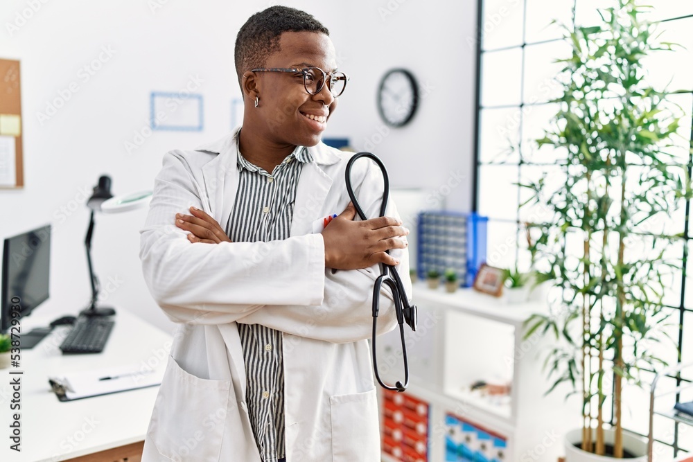 Young african man working as doctor holding stethoscope at medical ...