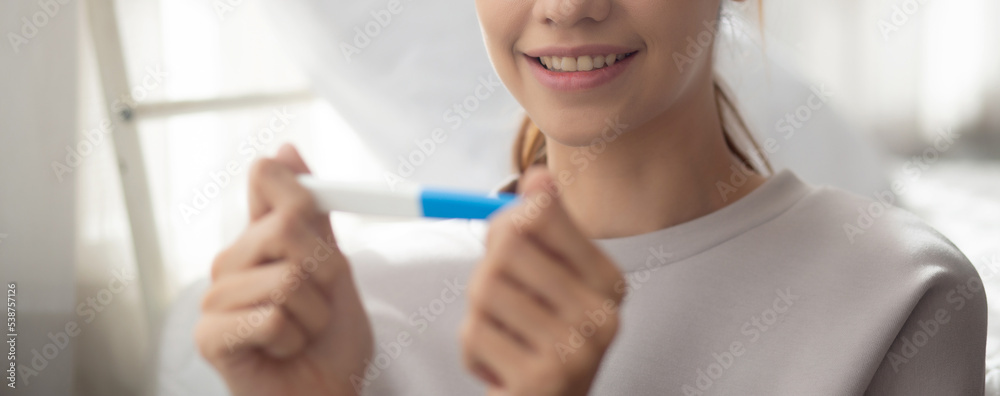 Happiness young asian woman taking pregnancy test while excited and ...