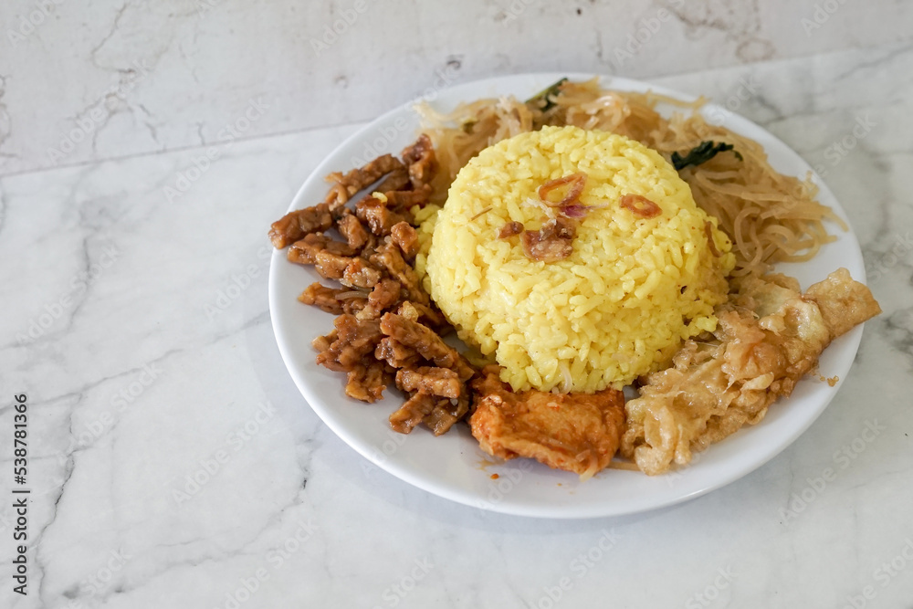 Nasi kuning, yellow rice or tumeric rice is traditional food from asia ...