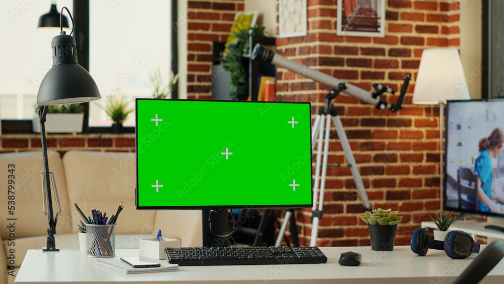 Greenscreen display on computer with empty desk in living room ...
