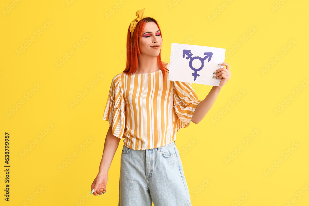 Stylish transgender woman holding paper sheet with transgender symbol ...