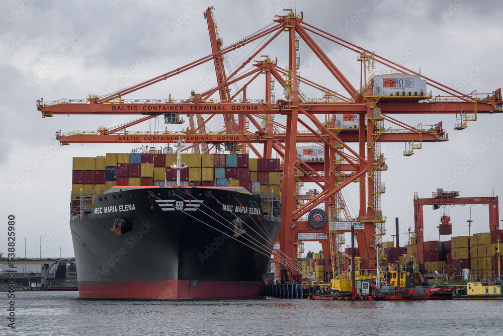 GDYNIA - POLAND - 2022: Transshipment of a container ship at the quay ...