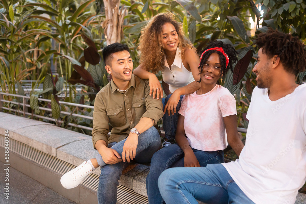 Smiling multiracial friends spending leisure time on wall Stock Photo ...