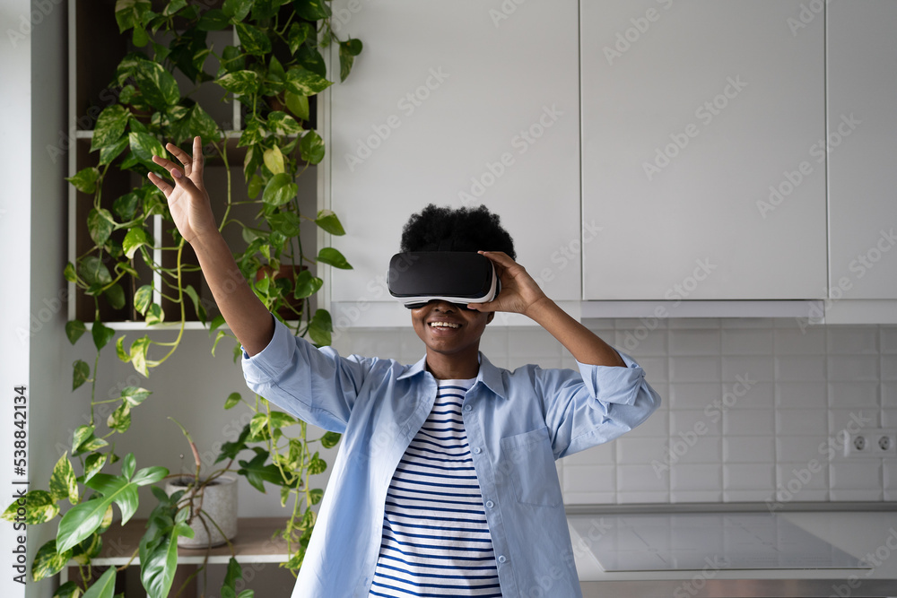 Impressed African American woman with hand raised testing virtual ...