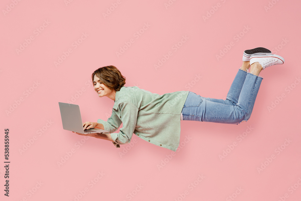 Full body side view young fun happy IT woman 20s she wear green shirt ...