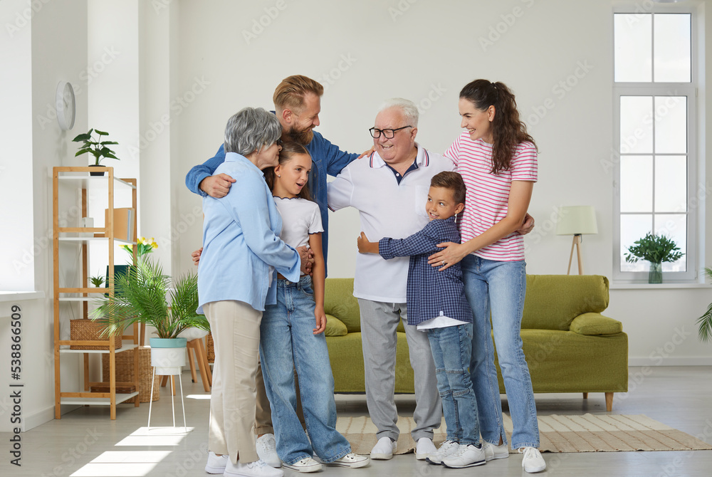 Happy multigenerational family having fun together. Joyful parents, grandparents and children ...