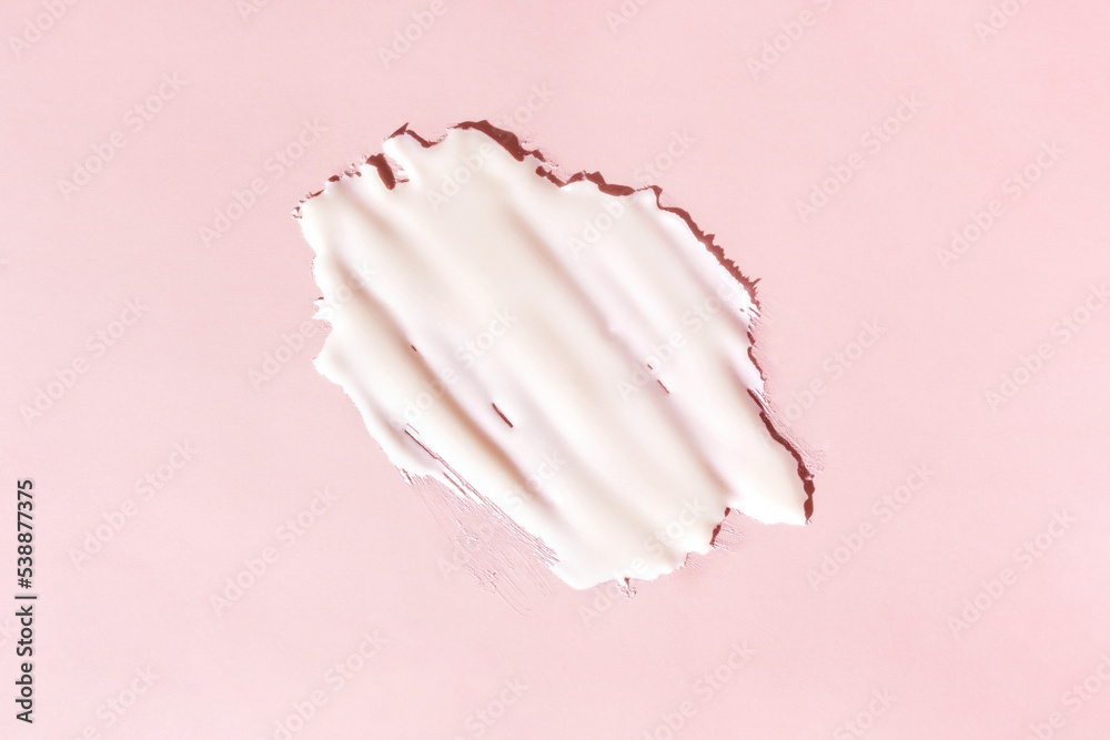 Cosmetic cream smear on pastel pink background. Lotion or creme swatch ...