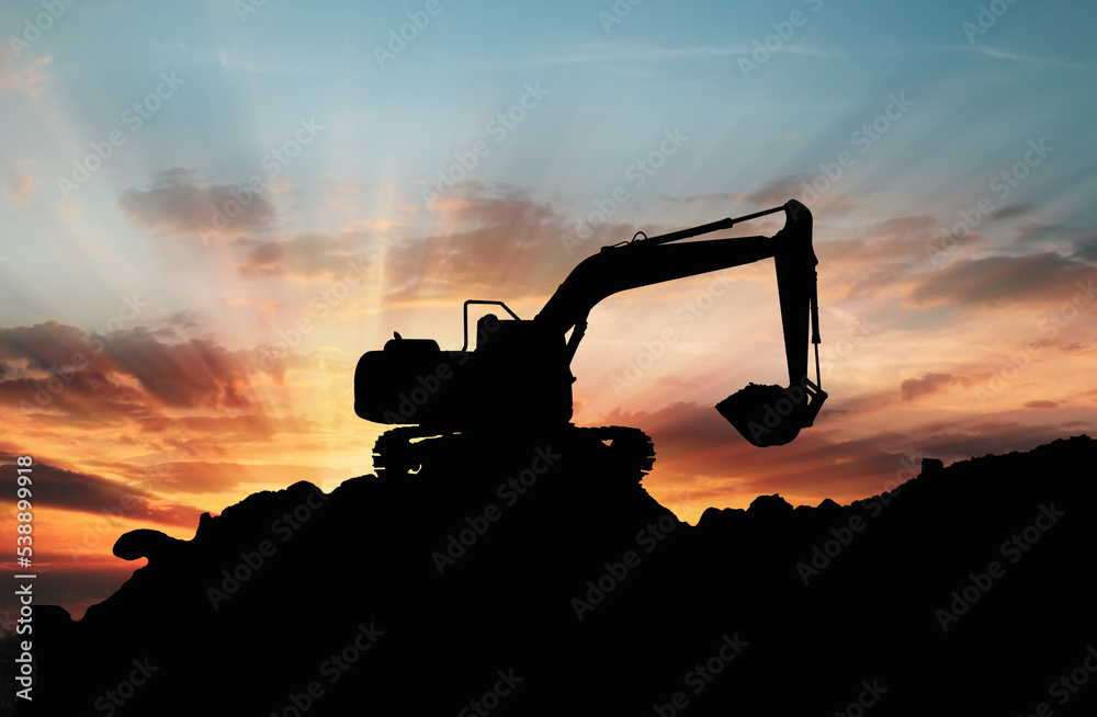 Crawler excavators silhouette are digging the soil in the construction ...