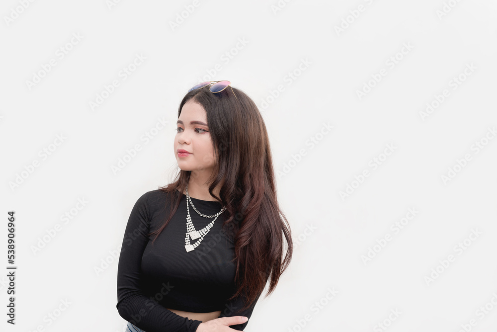 A teenage girl does a side view pose for the camera for a studio shot ...