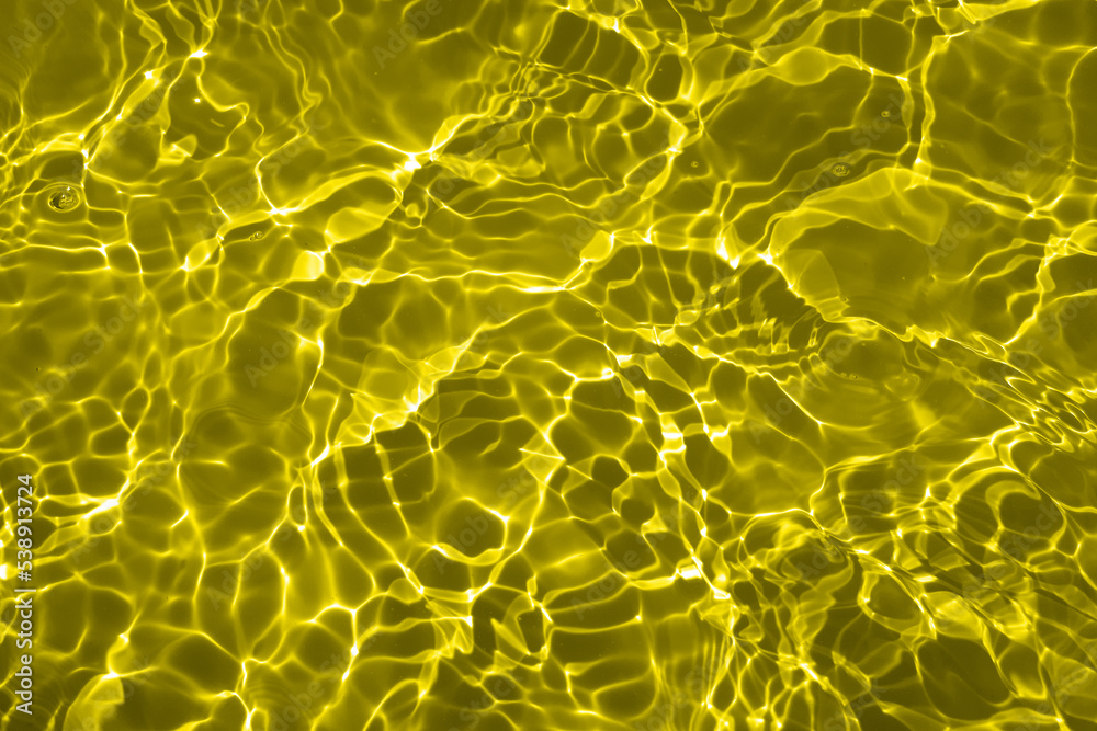 Yellow water colored clear calm water surface texture with splash ...